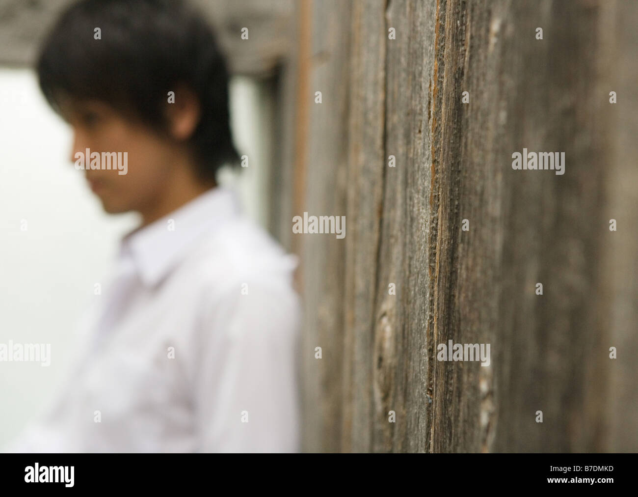 Man leaning against wall Stock Photo - Alamy