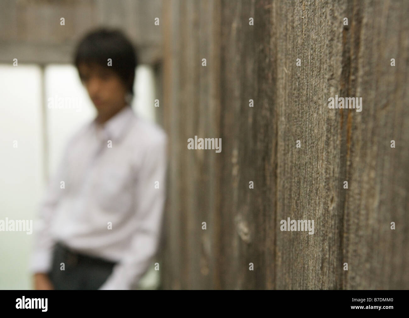 Man leaning against wall Stock Photo - Alamy