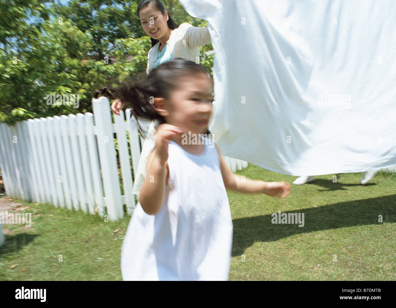 Girl playing in yard Stock Photo - Alamy
