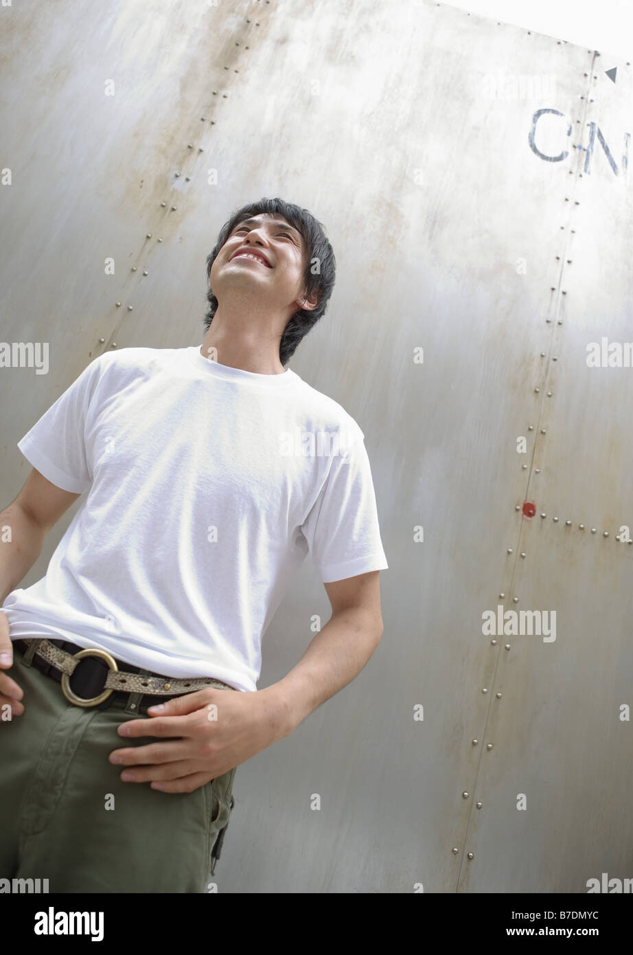 Young black man standing wall hi-res stock photography and images - Alamy