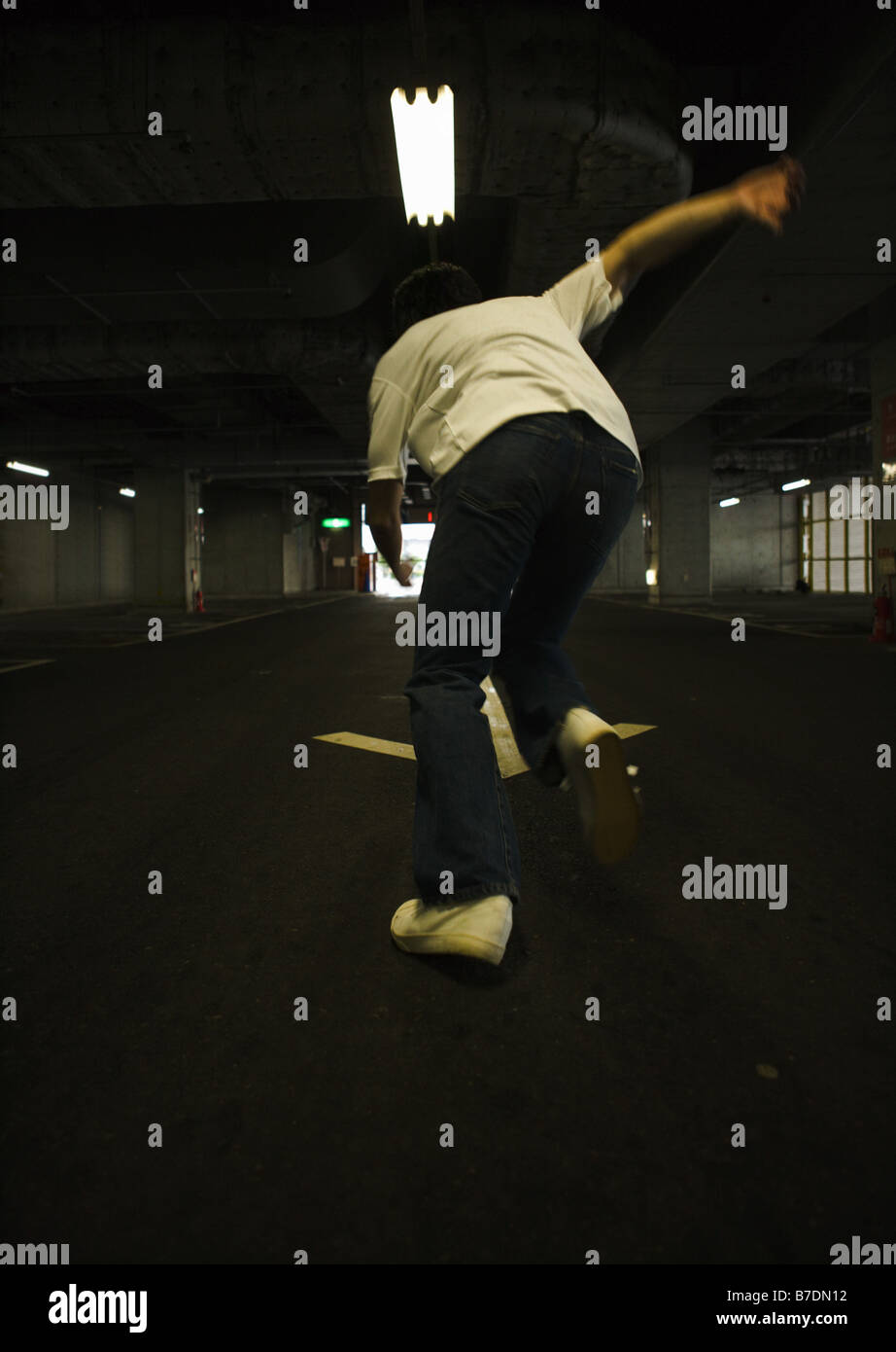 Man running in parking lot Stock Photo - Alamy