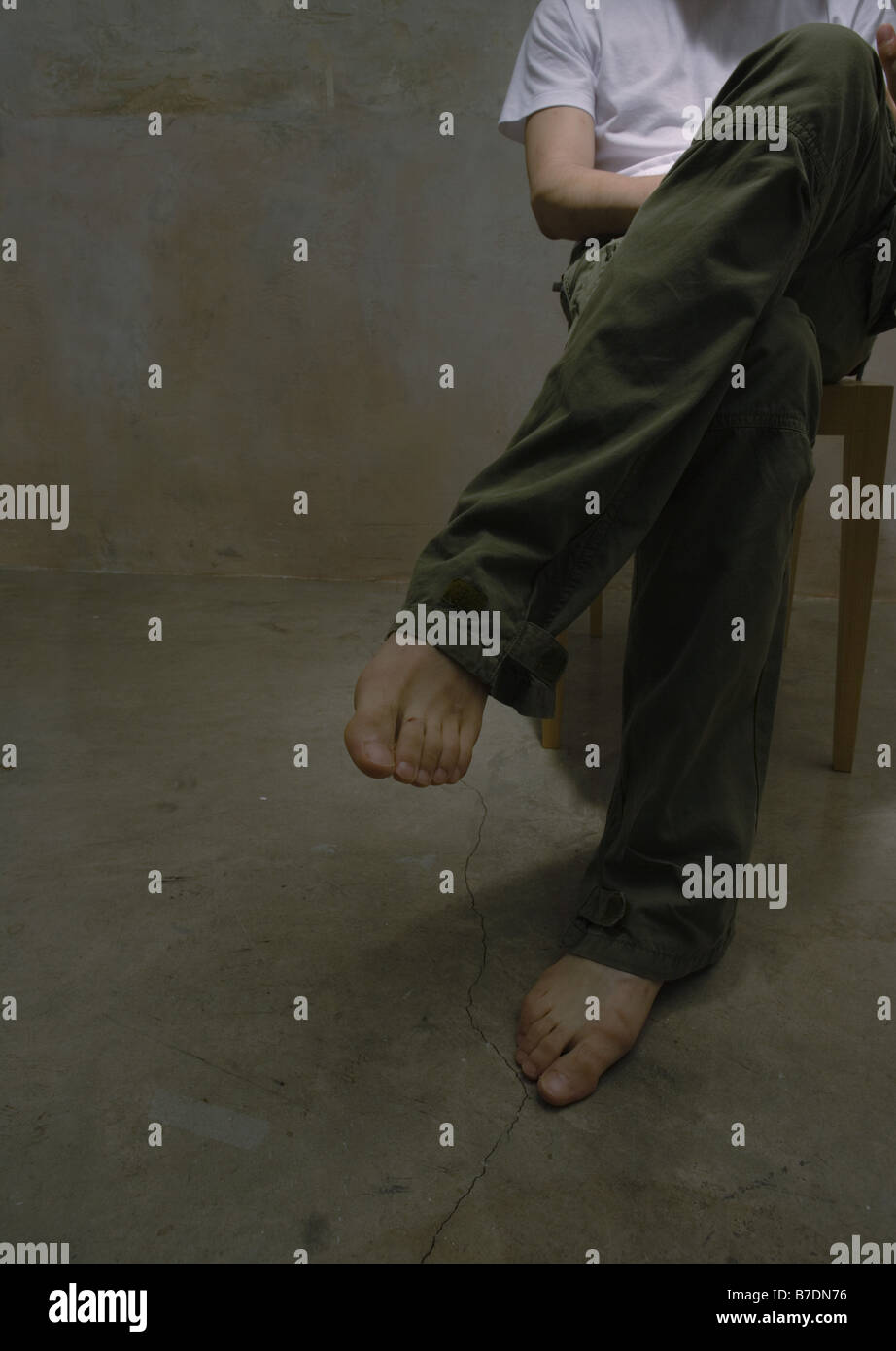 Man crossing legs Stock Photo - Alamy
