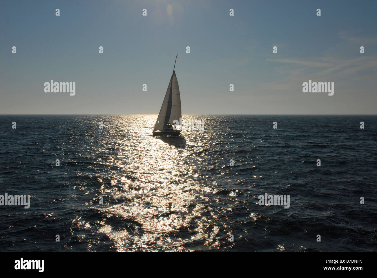 Sailboat alone in the ocean Stock Photo - Alamy