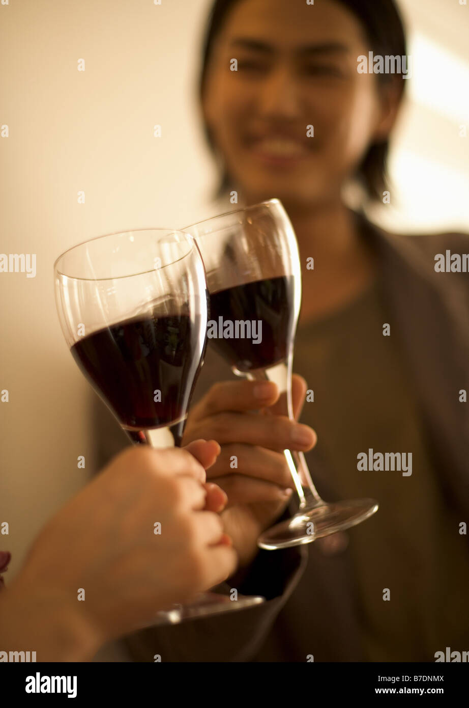 A couple toasting with red wine Stock Photo - Alamy