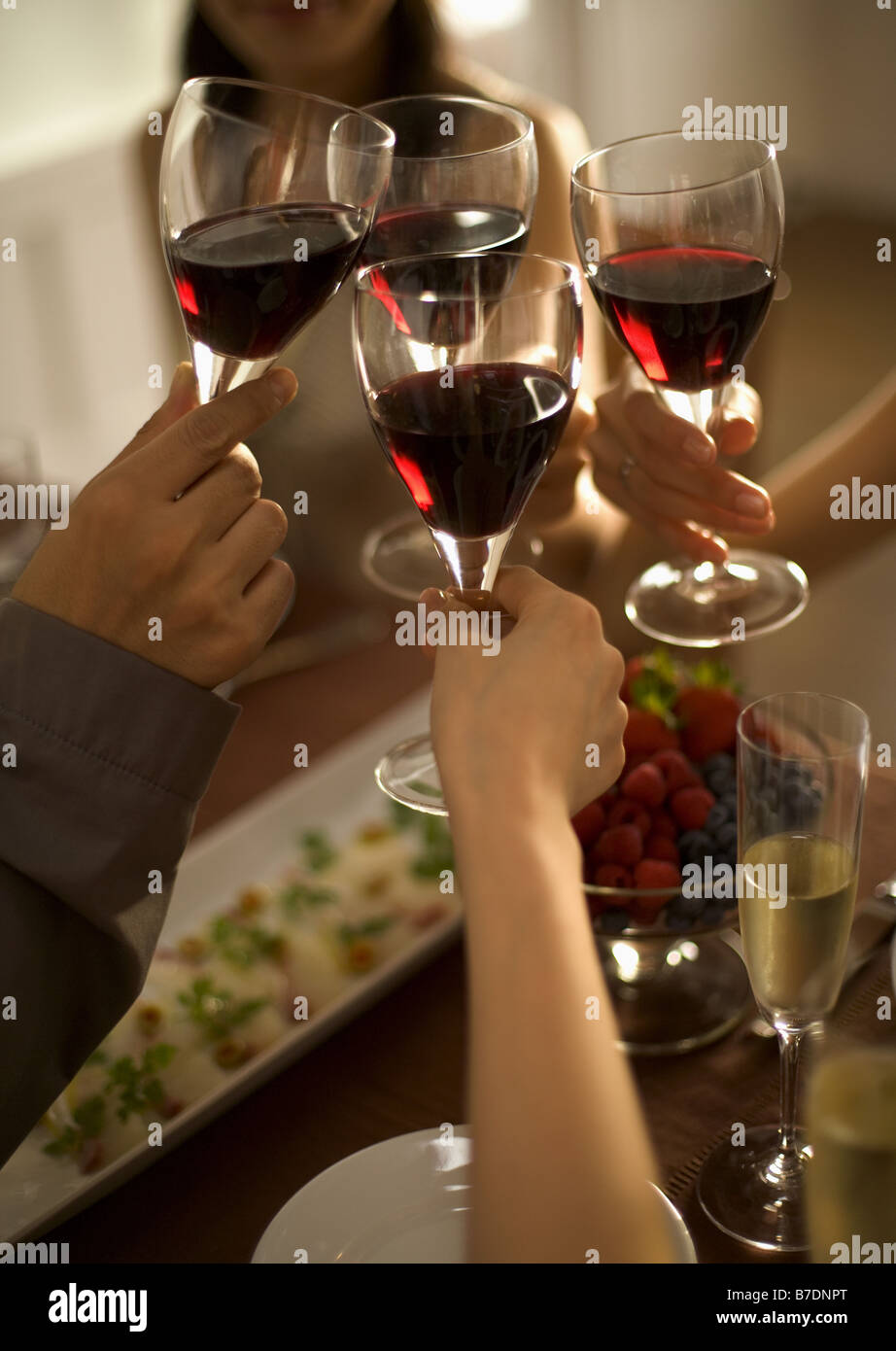 Toasting with red wine Stock Photo - Alamy