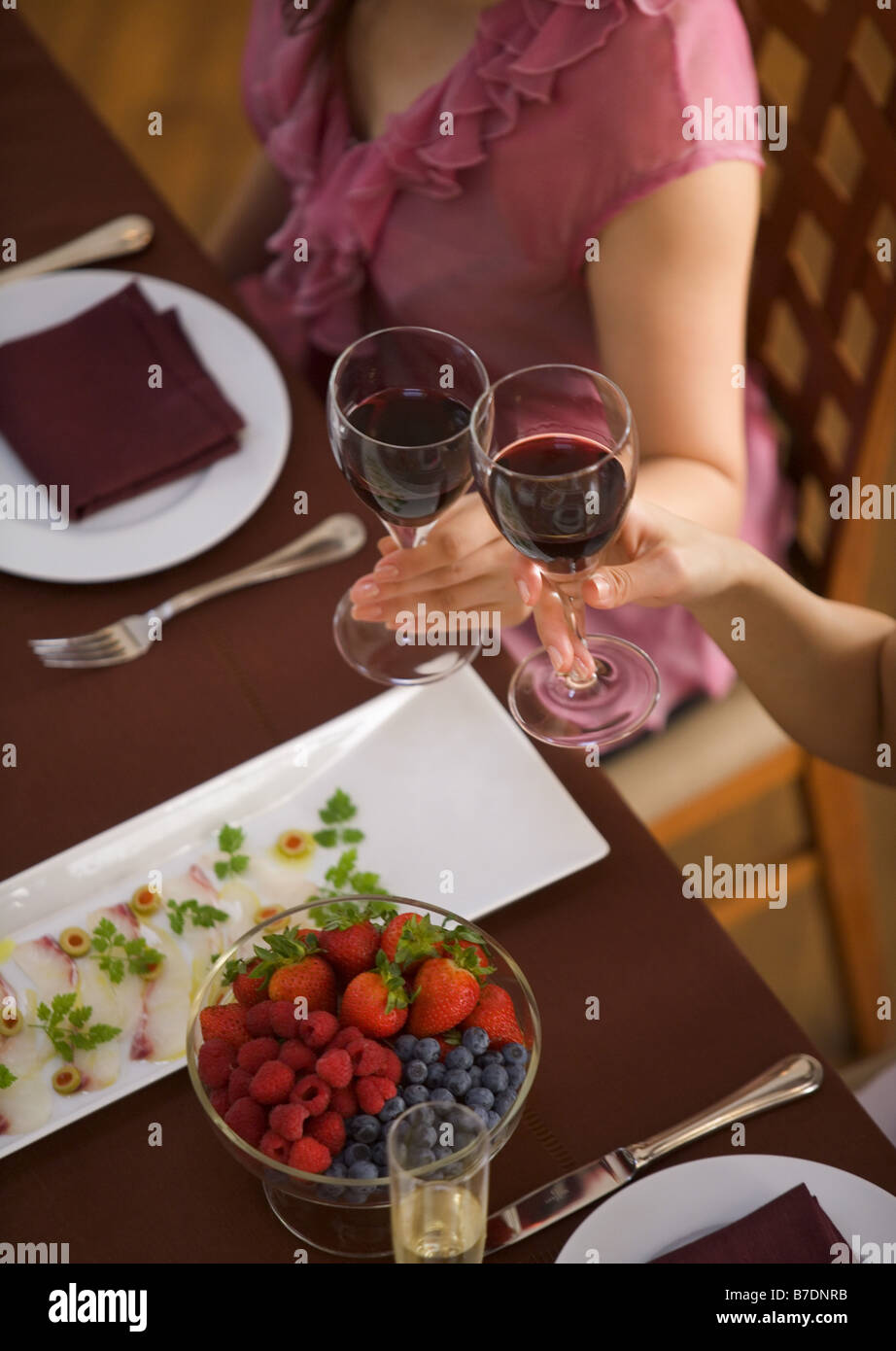 Toasting with red wine Stock Photo - Alamy