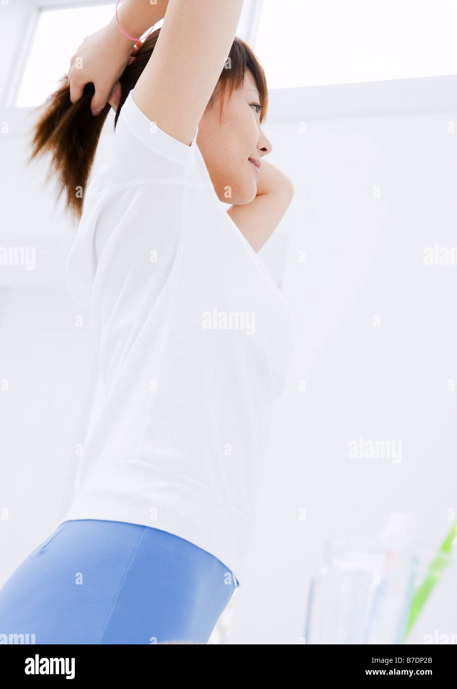 Woman catching up hair Stock Photo - Alamy