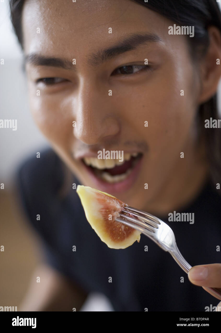 Man eating fig Stock Photo - Alamy
