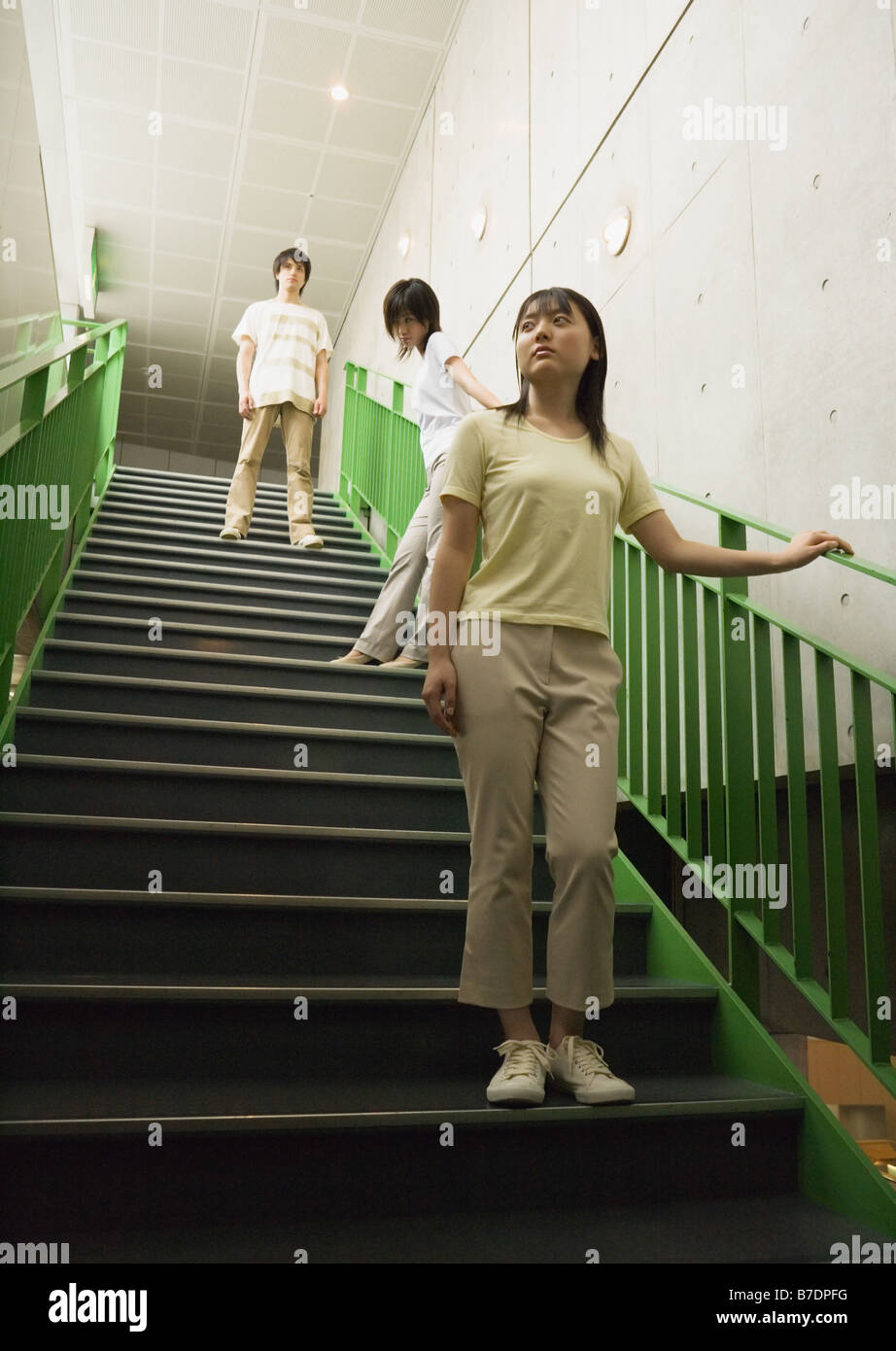 Young people standing on stairs Stock Photo - Alamy