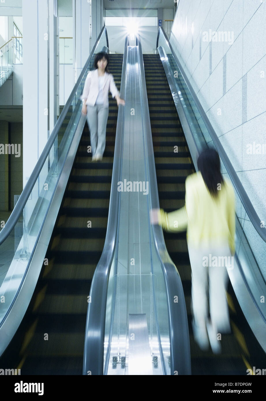 Two people escalator up and down hi-res stock photography and images ...