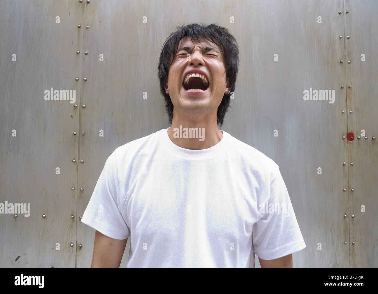 Young man shouting Stock Photo - Alamy
