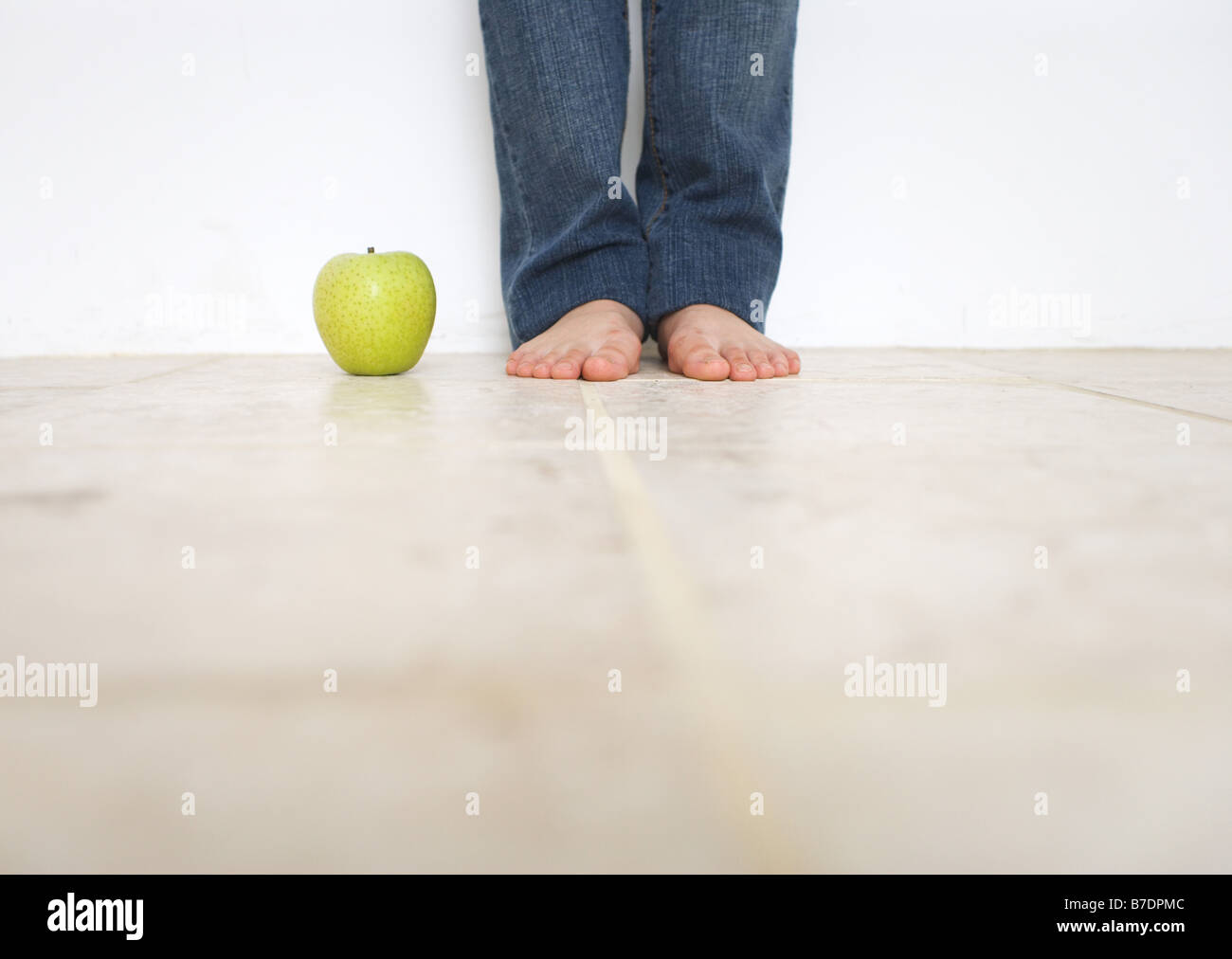Woman's barefoot and green apple Stock Photo - Alamy