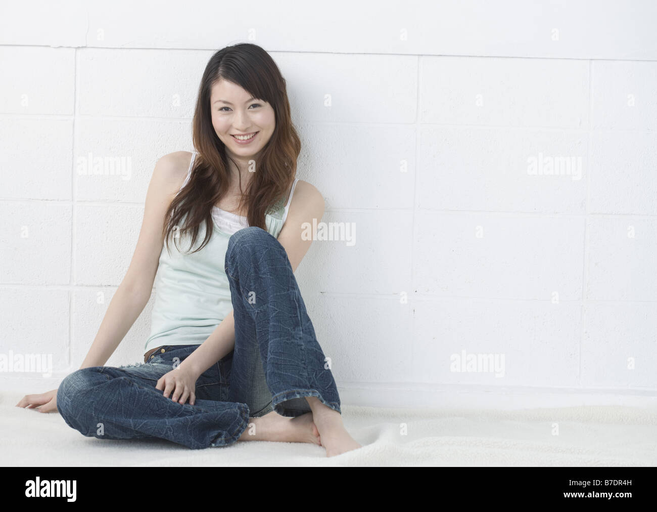 Woman sitting on floor Stock Photo - Alamy