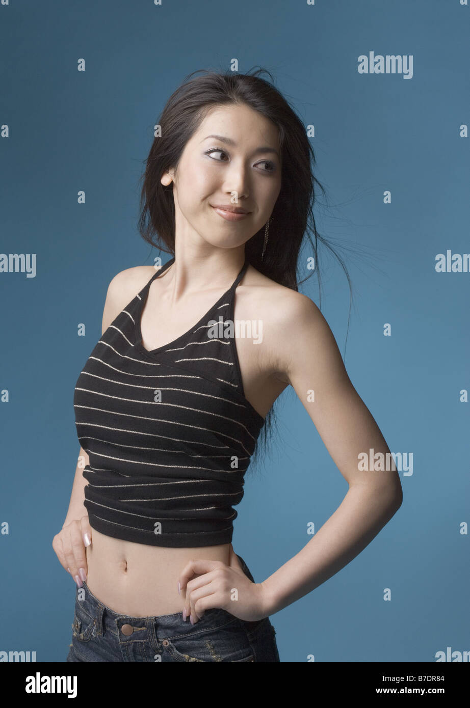 Woman with long hair looking away Stock Photo - Alamy
