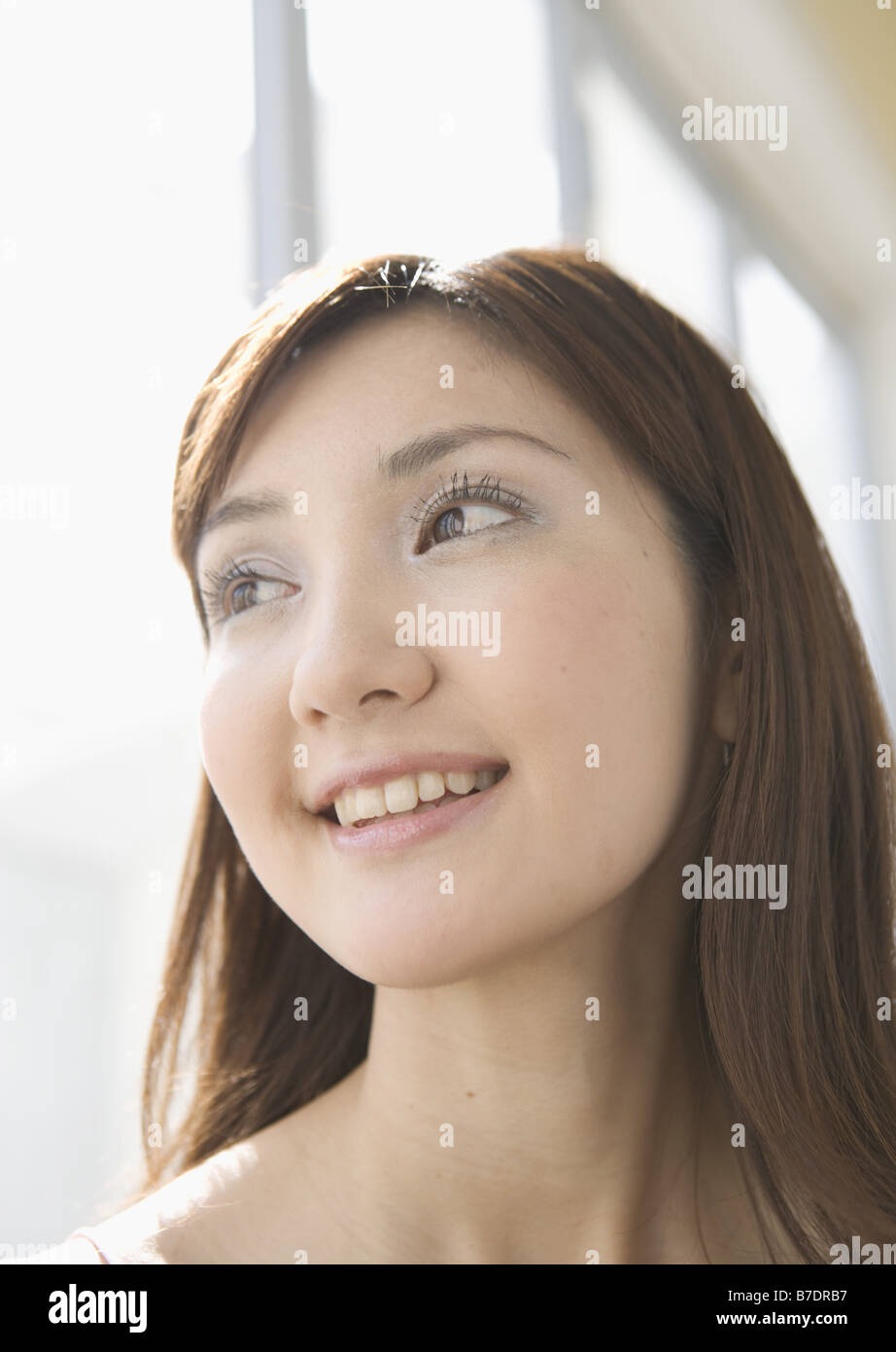 Woman with long hair smiling Stock Photo - Alamy