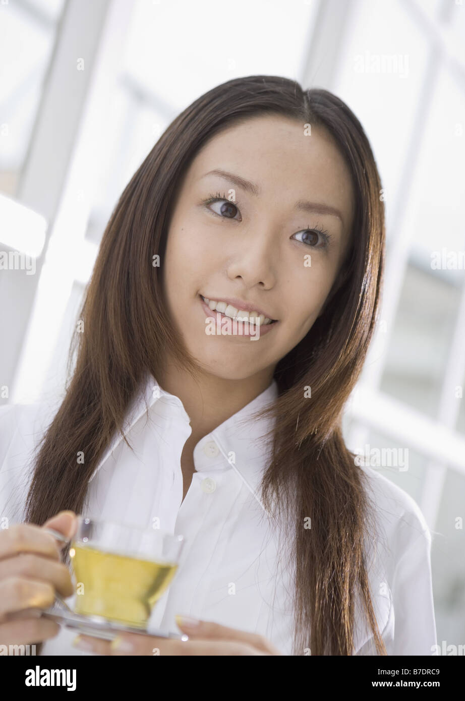 Young woman having tea time Stock Photo - Alamy
