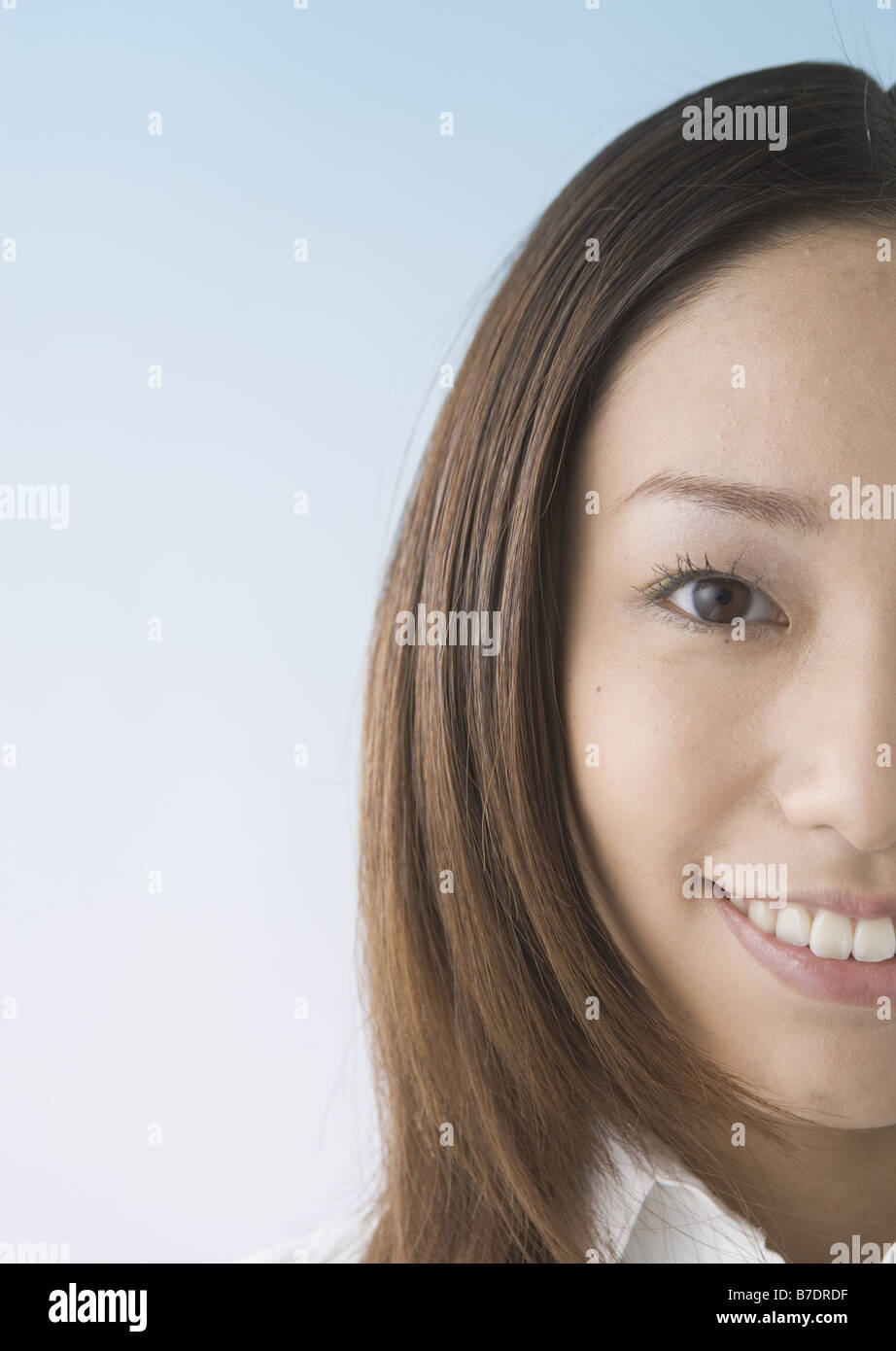 Young woman with long hair smiling Stock Photo - Alamy