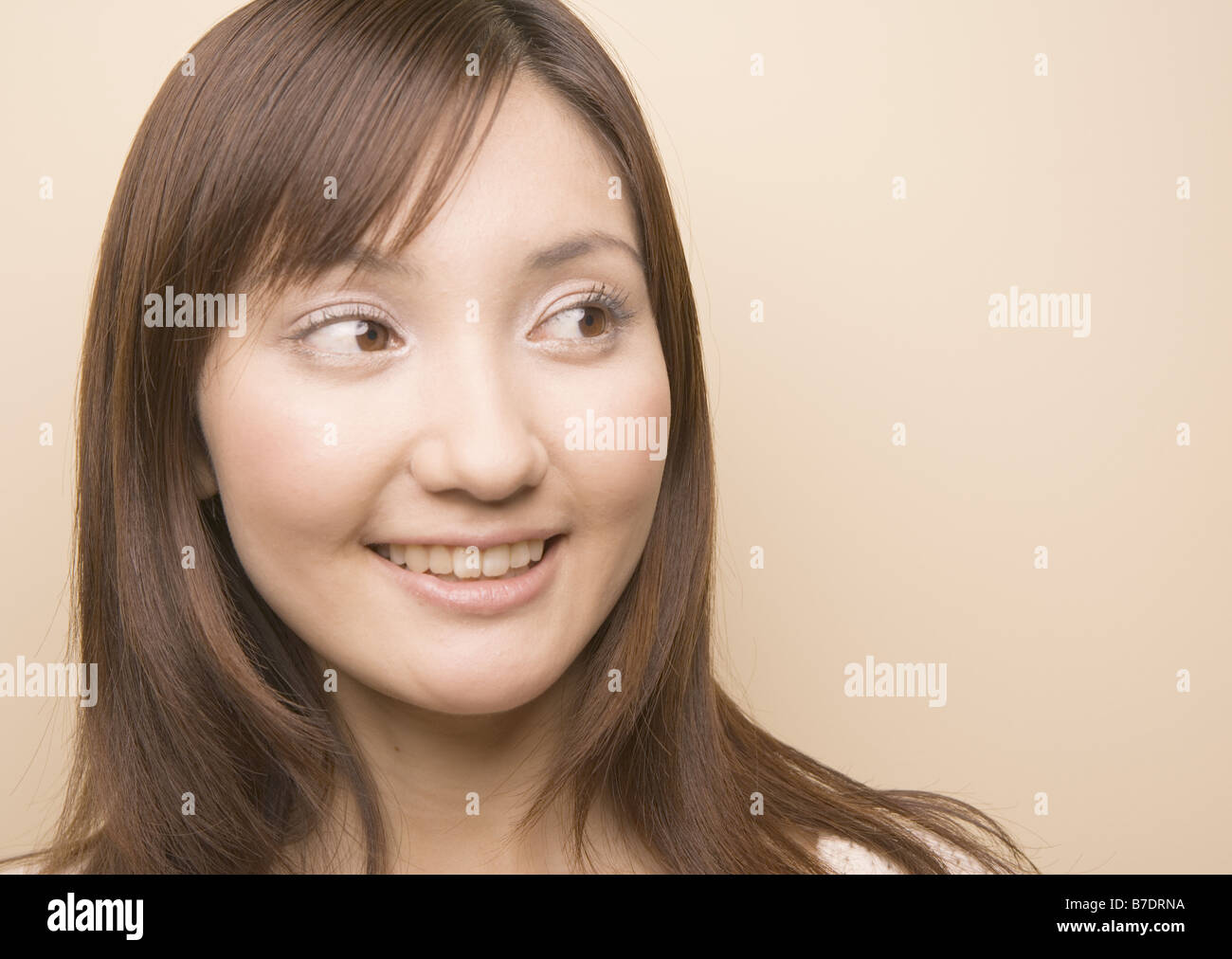 Woman with long hair smiling Stock Photo - Alamy