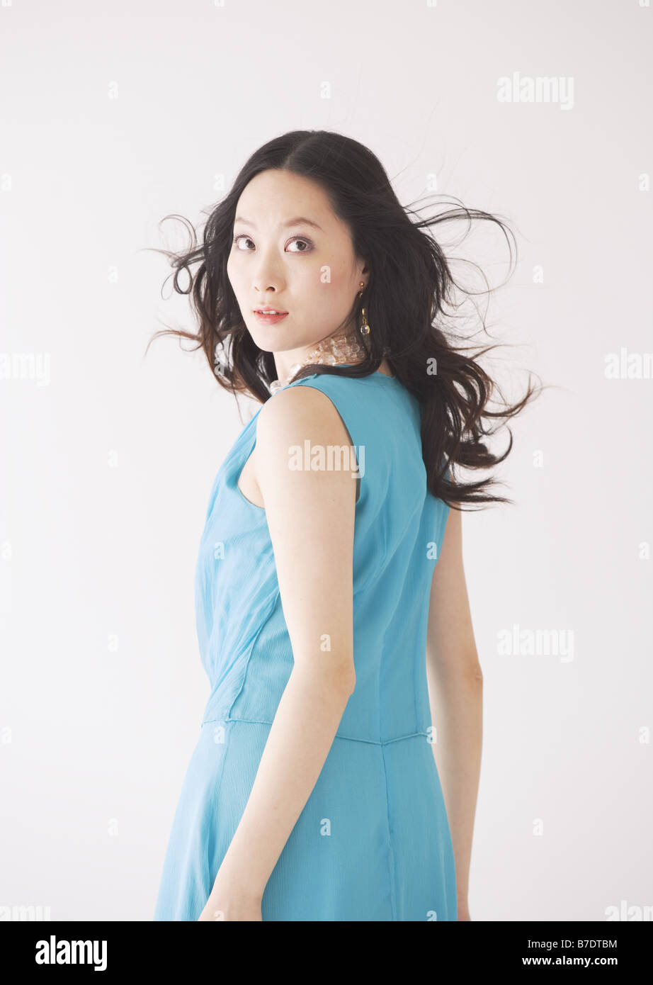 Woman looking over shoulder Stock Photo - Alamy