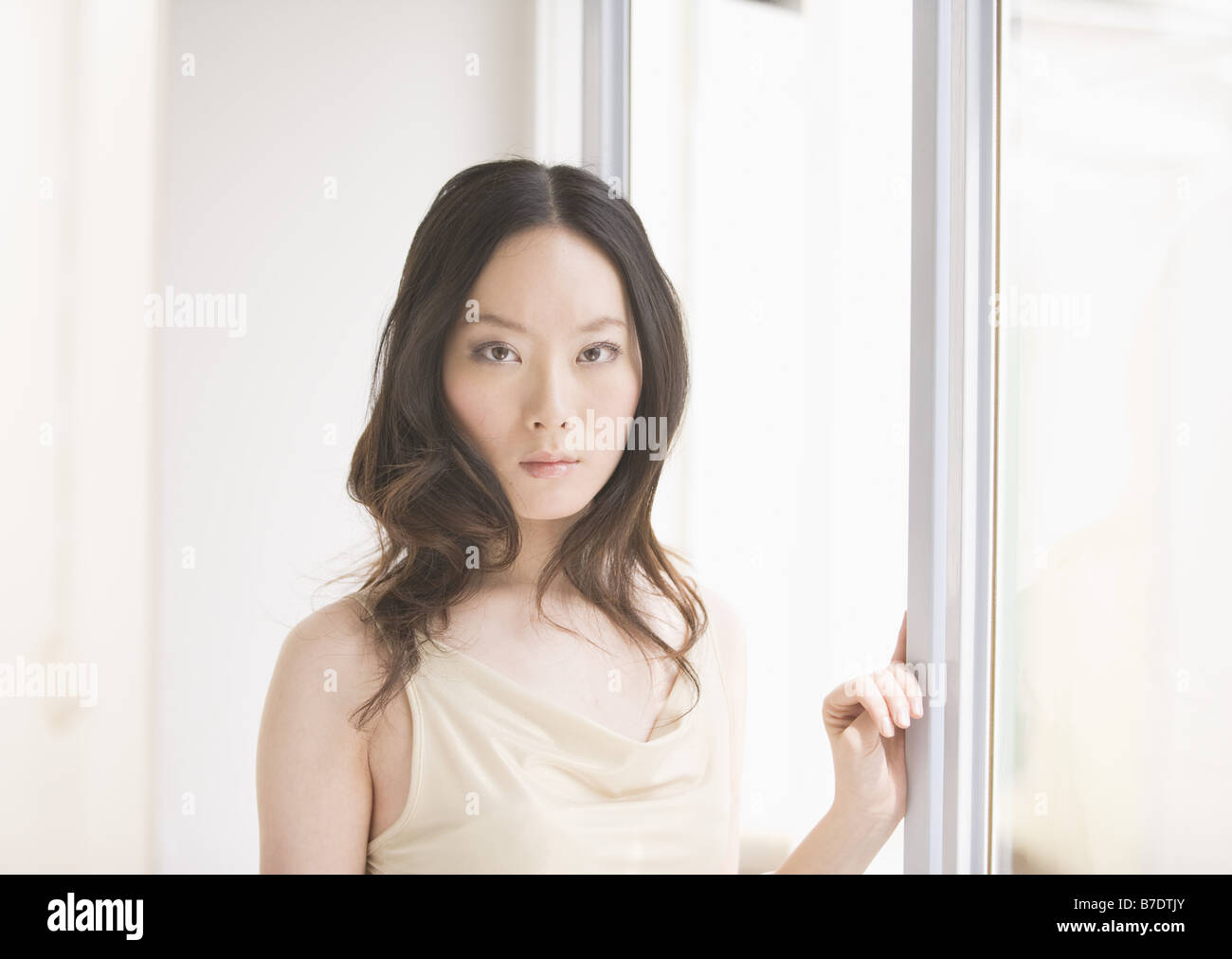 Woman by the window Stock Photo - Alamy