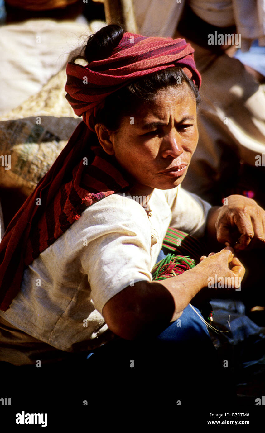 Traditionally dressed Burmese people and vendors at market on Inle Lake ...