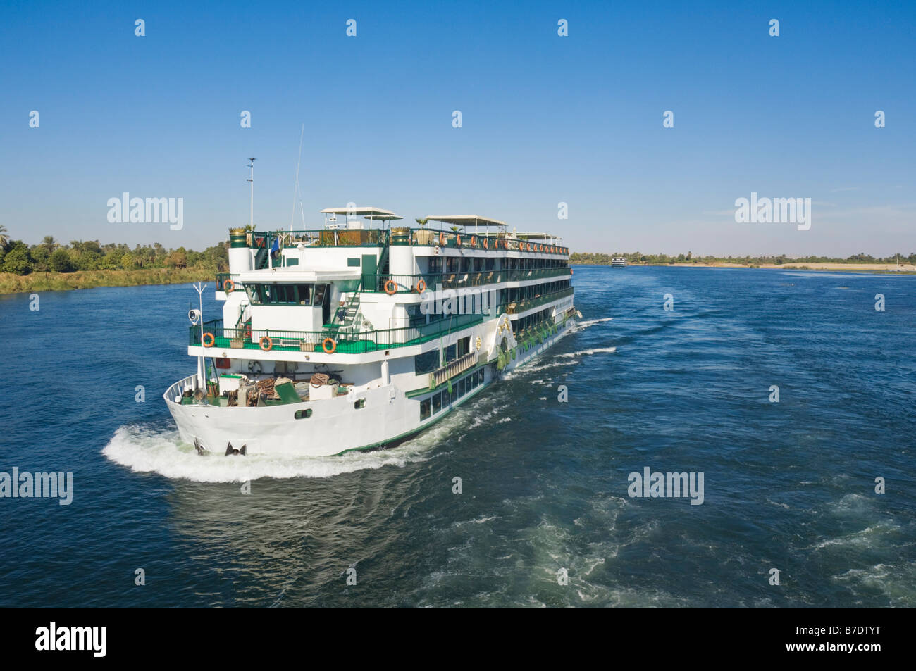 Tourist cruise boat travelling down the River Nile towards Aswan from ...