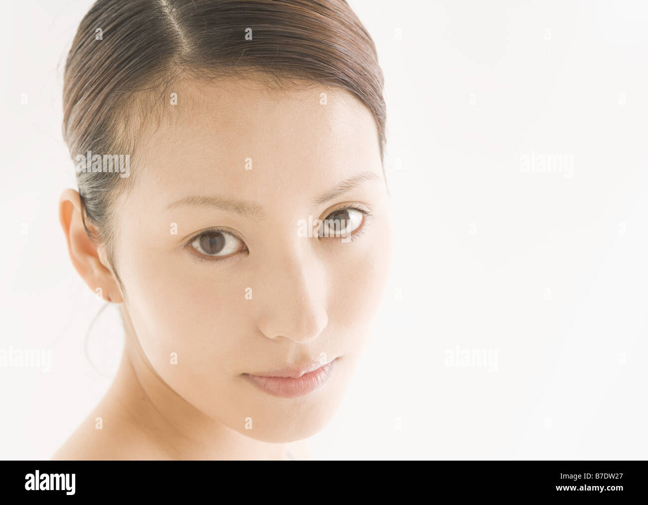 Woman looking over shoulder Stock Photo - Alamy