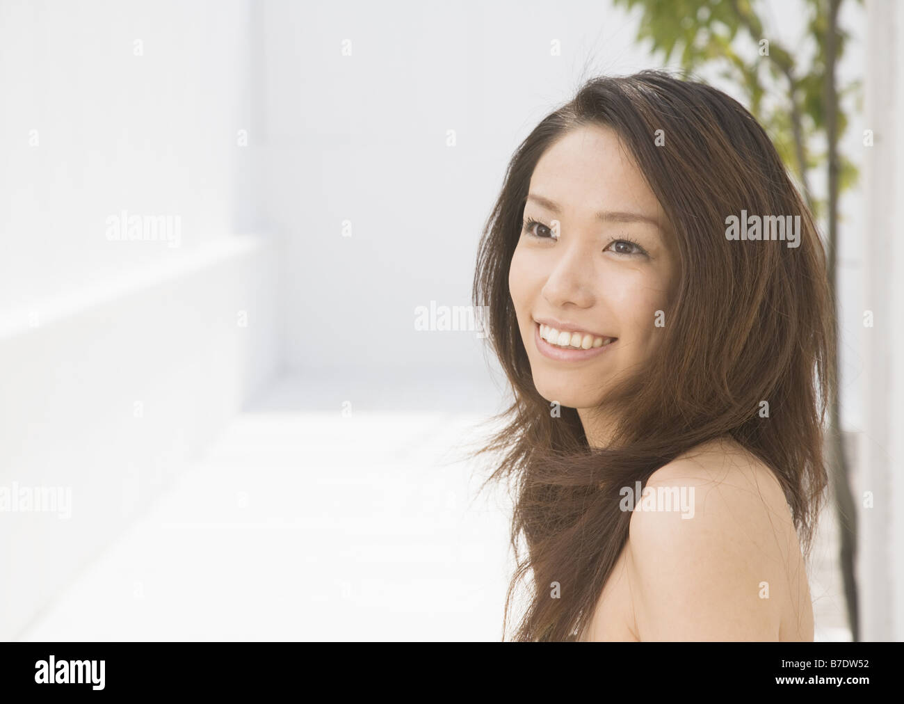 Smiling woman with long hair Stock Photo - Alamy