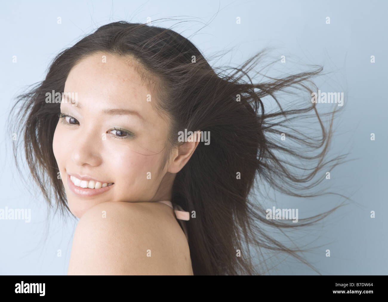 Woman looking over shoulder Stock Photo - Alamy