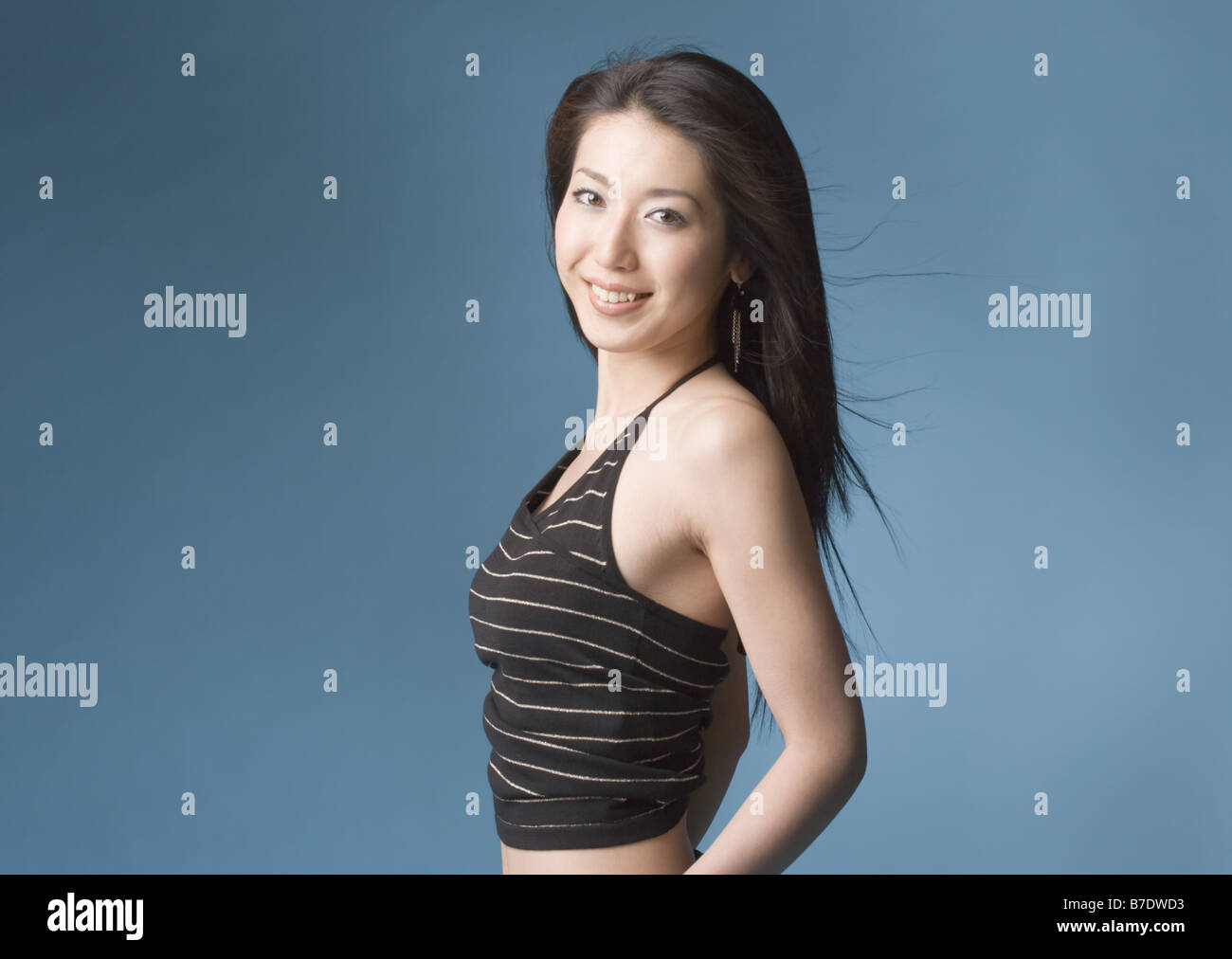 Woman looking over shoulder Stock Photo - Alamy