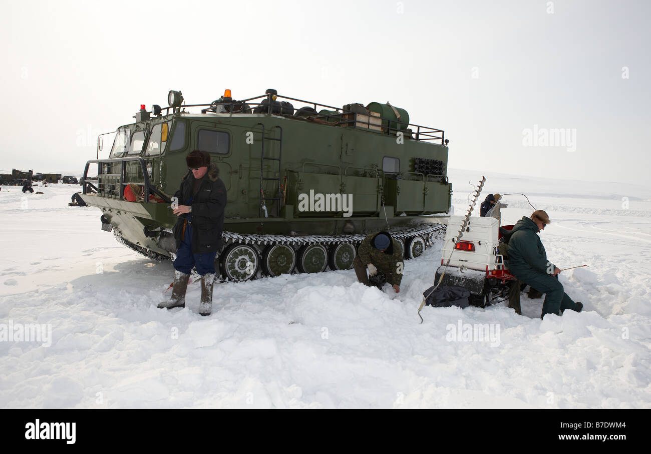 Ice fishing for smelts in front of modified tank, (Vezdekhod) Anadyr ...