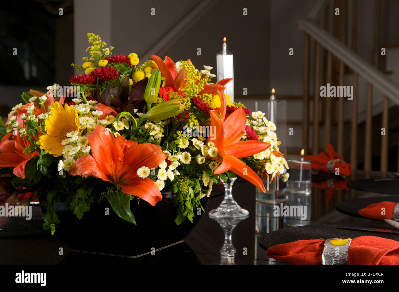 A bouquet of autumnal flowers adorns a formal table setting Stock Photo ...
