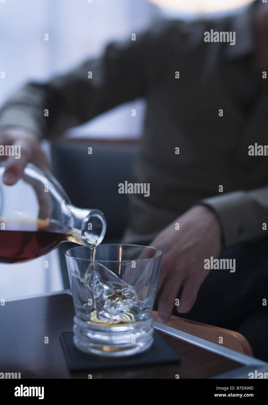 Man pouring brandy Stock Photo - Alamy