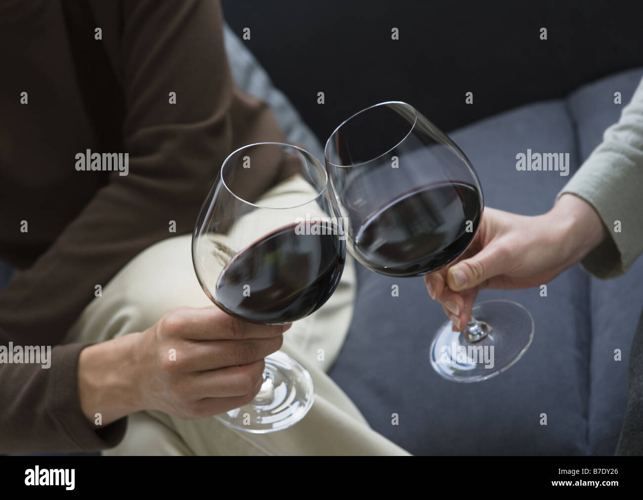 Clinking wine glasses Stock Photo - Alamy