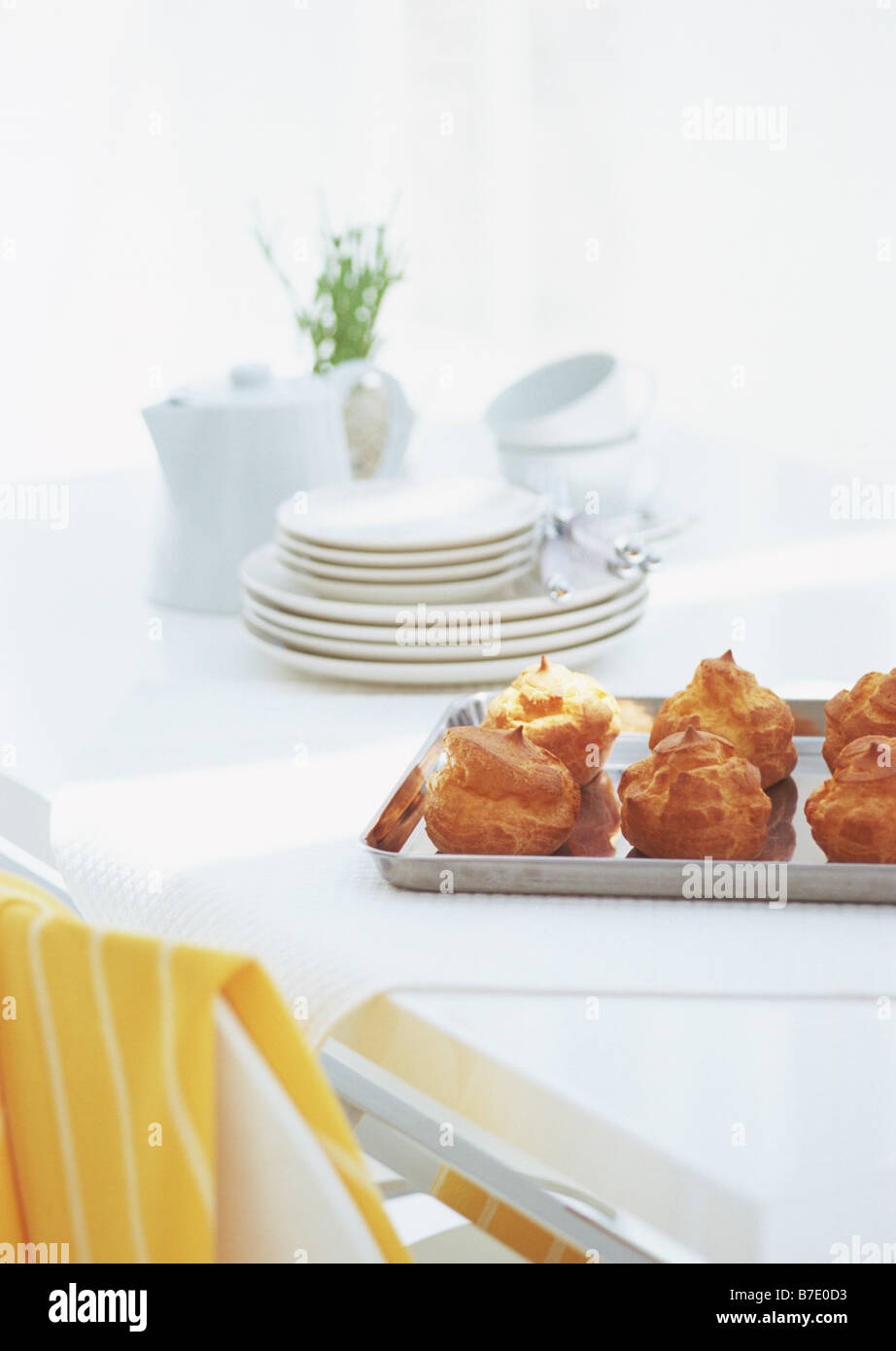 Cream puffs and dining table Stock Photo - Alamy
