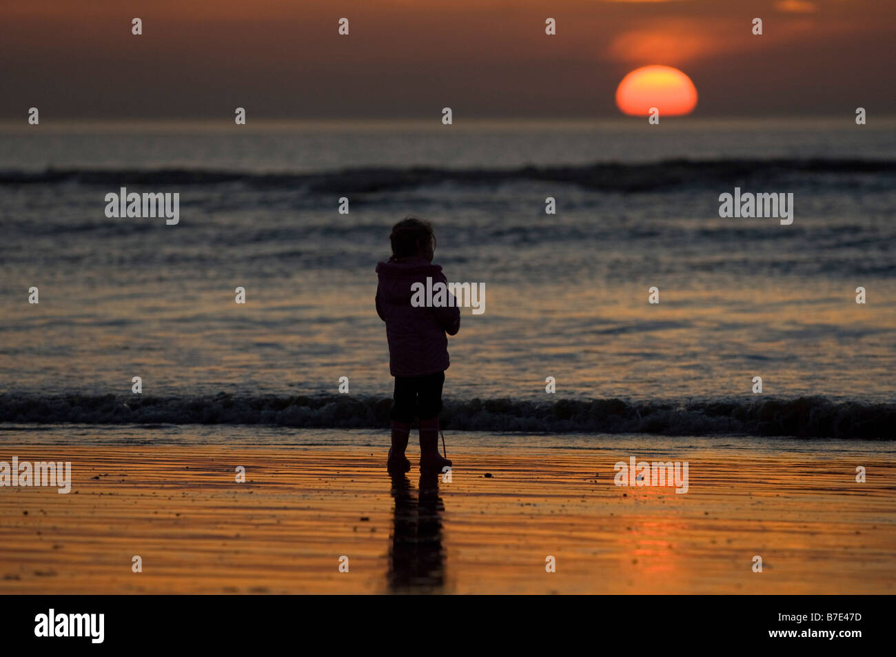 Alone on a beach at sunset hi-res stock photography and images - Alamy