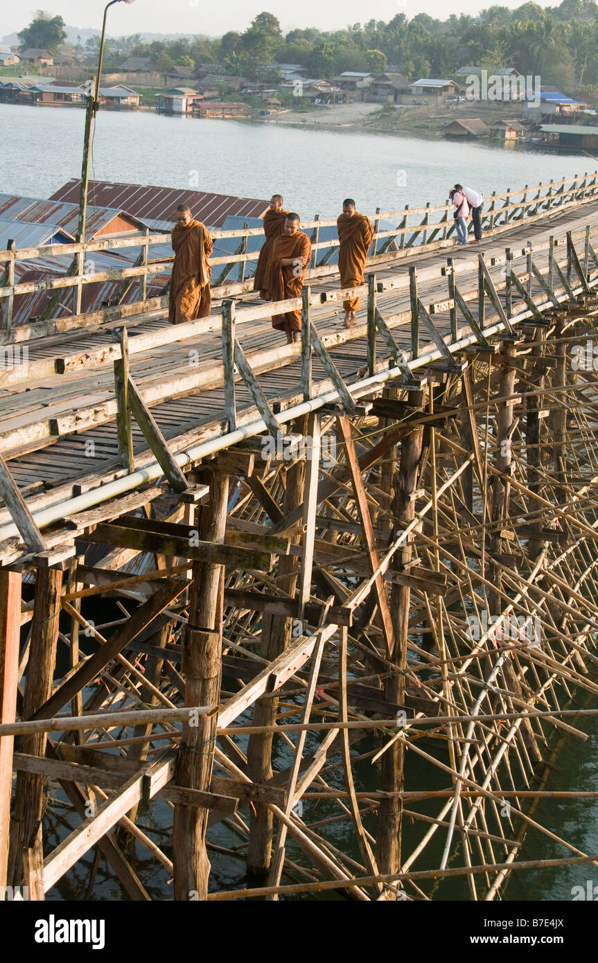 monks walking on long wooden teak bridge near the Burmese border in ...