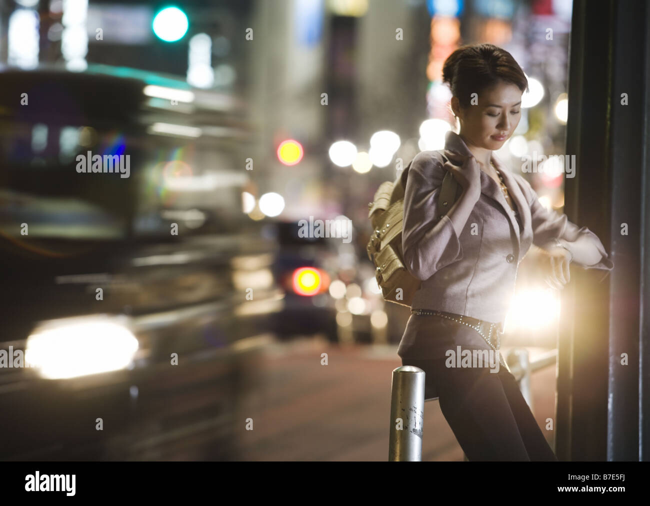 Woman in street corner Stock Photo - Alamy