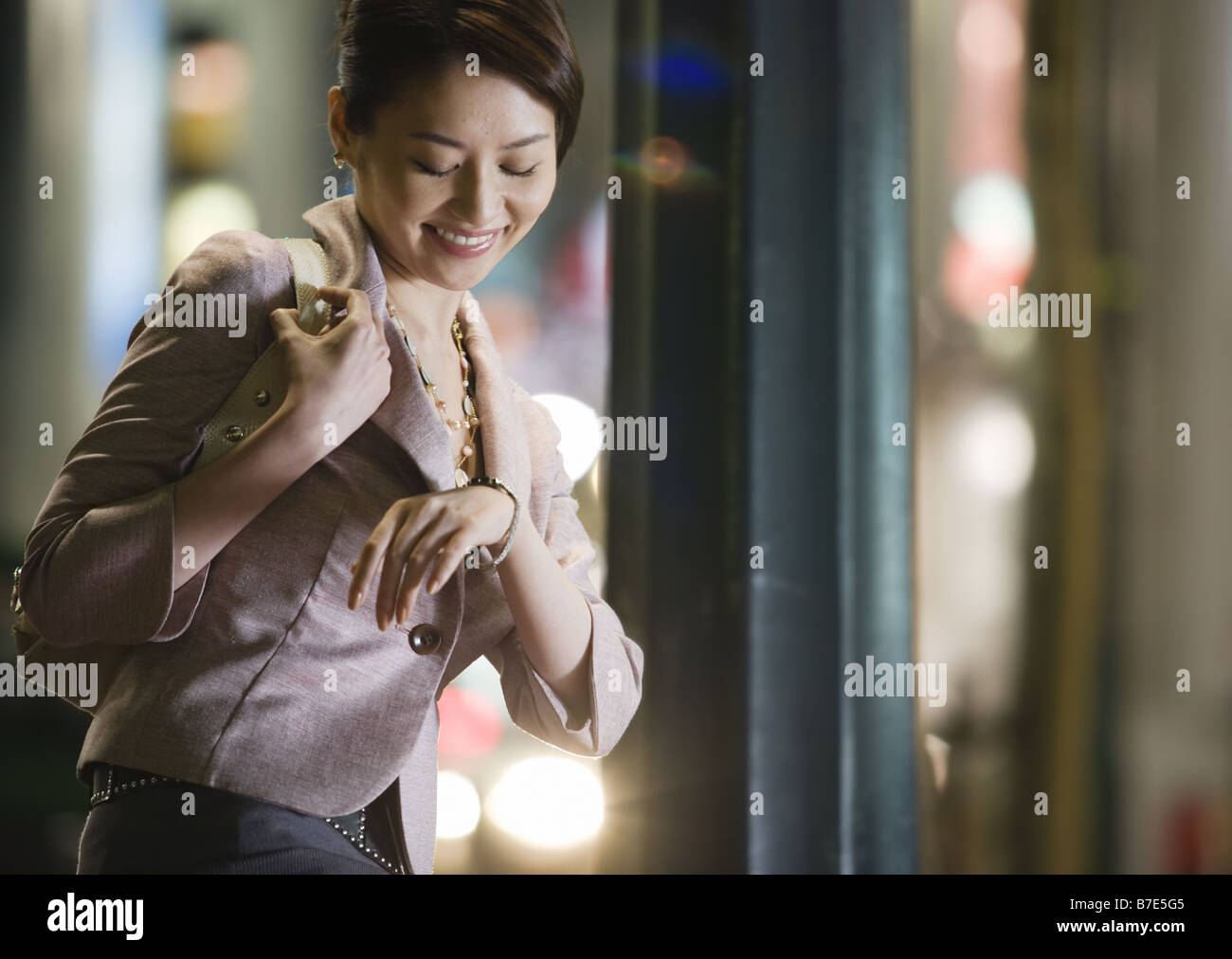 Woman going night street smiling hi-res stock photography and images ...