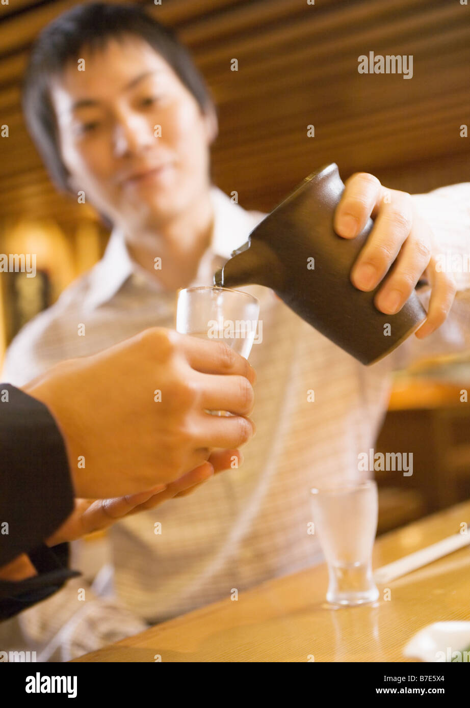 Man Pouring Japanese Sake Stock Photo - Alamy
