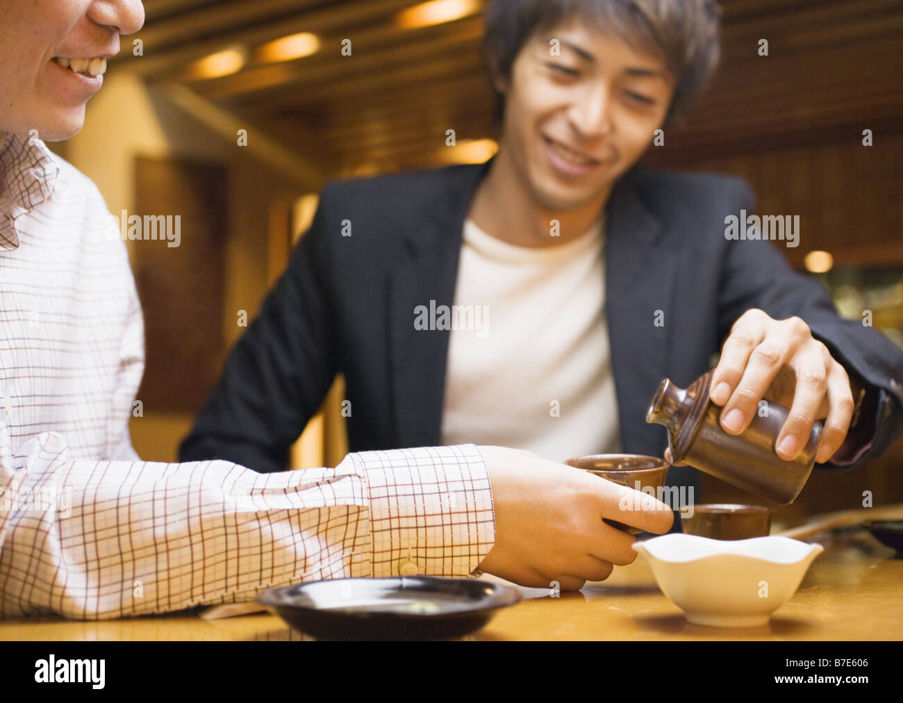 Man Pouring Sake Stock Photo - Alamy