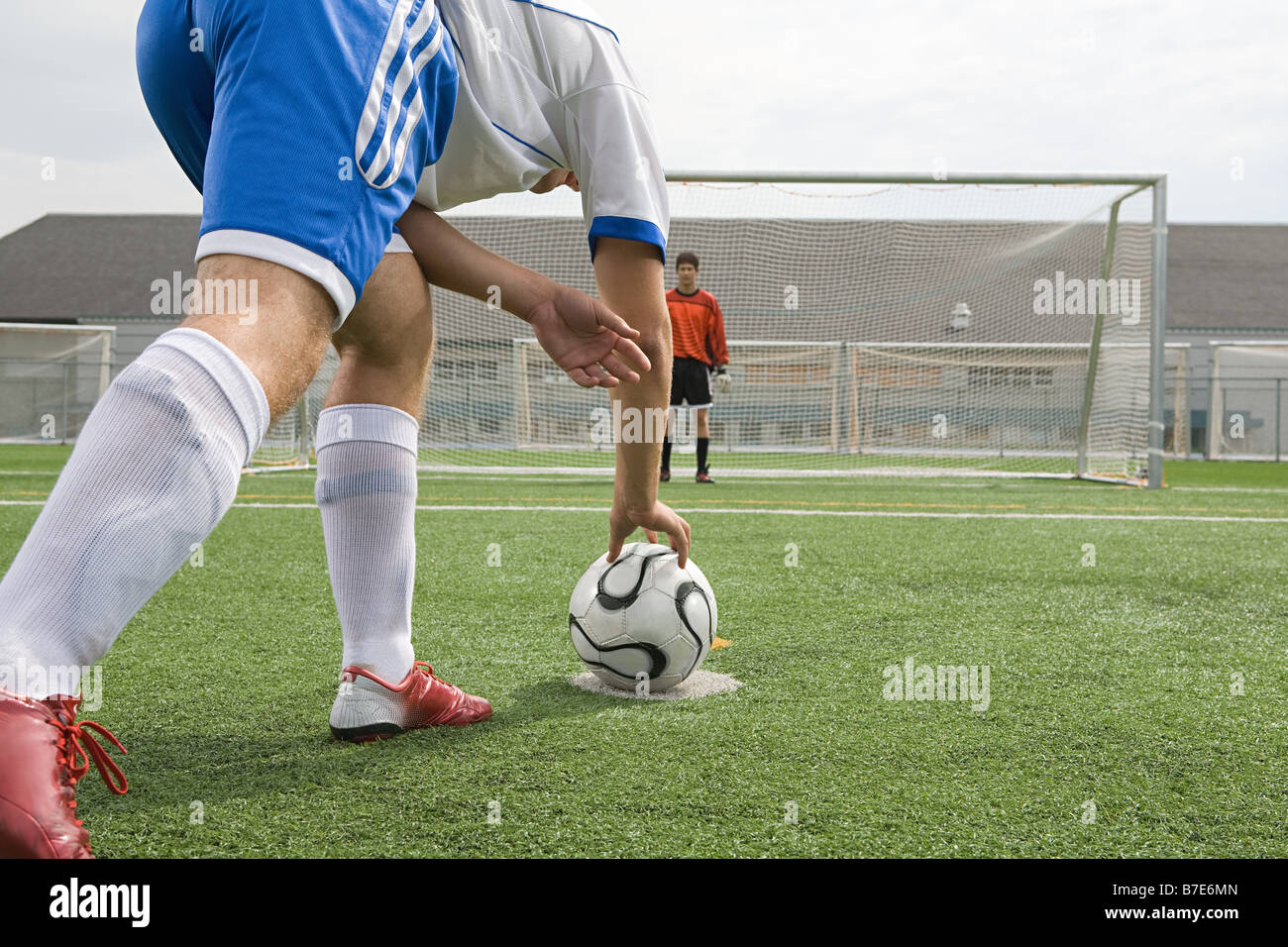 Footballer and goalkeeper Stock Photo - Alamy