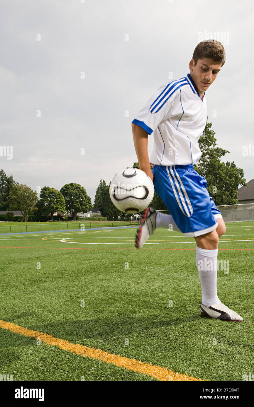 Boy playing football Stock Photo - Alamy
