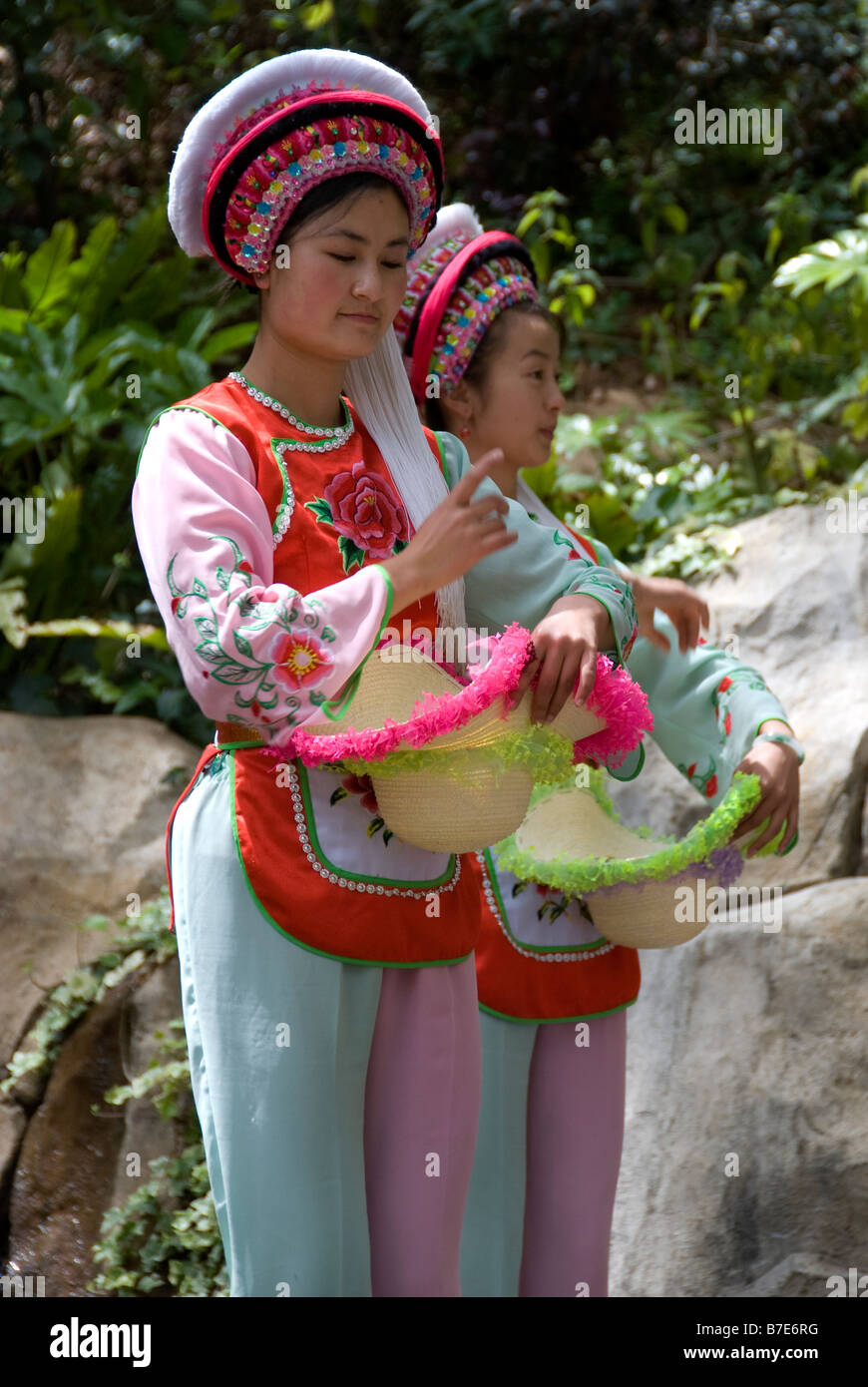 Two female Dai dancers wearing traditional costume with headdress and ...