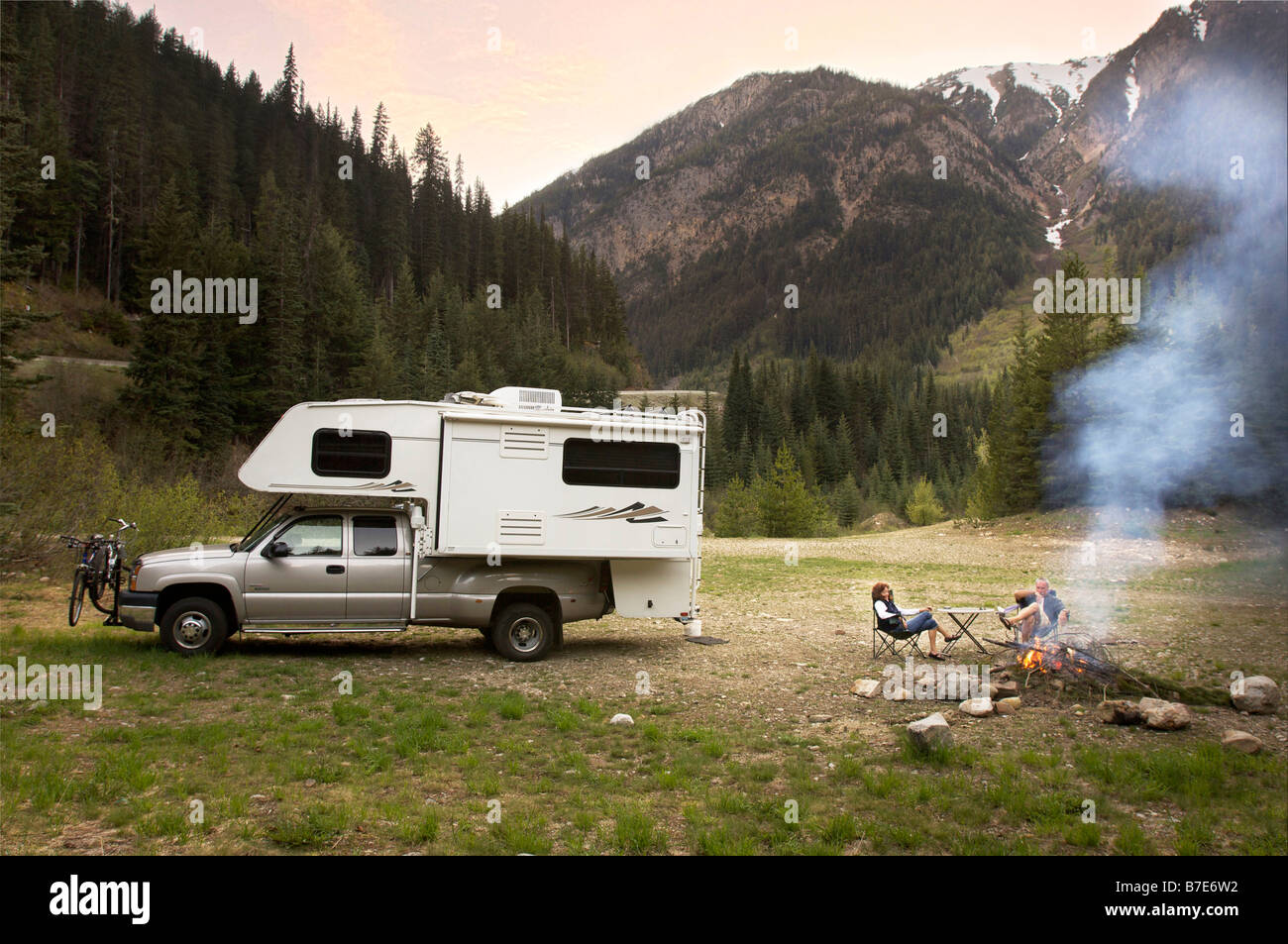A couple enjoys a fire by their camper Near Duffy lake on the Sea to ...