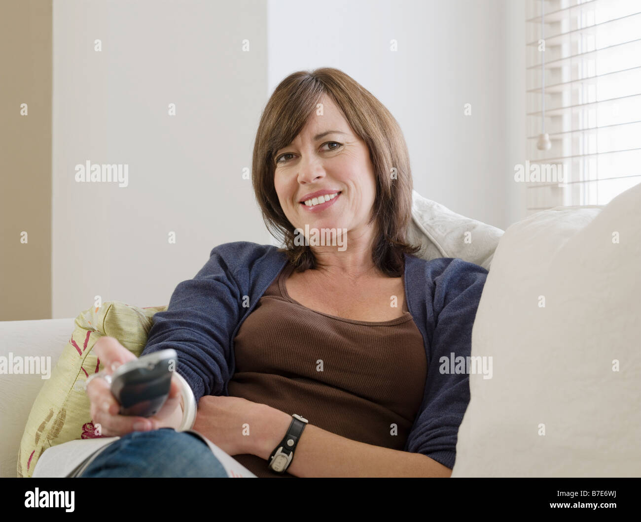 Portrait of a woman watching tv Stock Photo - Alamy