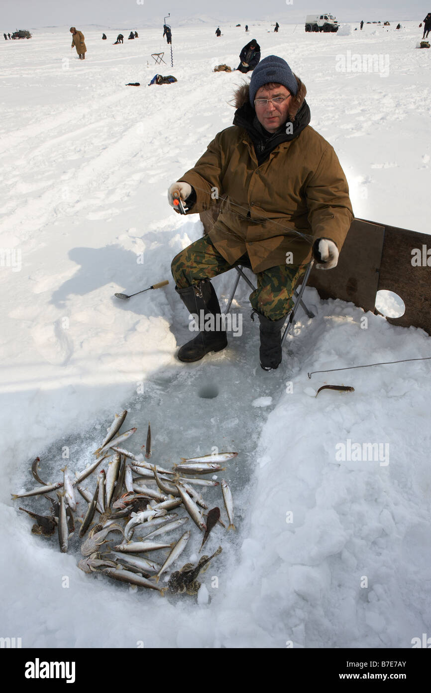 Man Ice fishing for smelts, Anadyr Chukotka, Siberia Russia Stock Photo ...