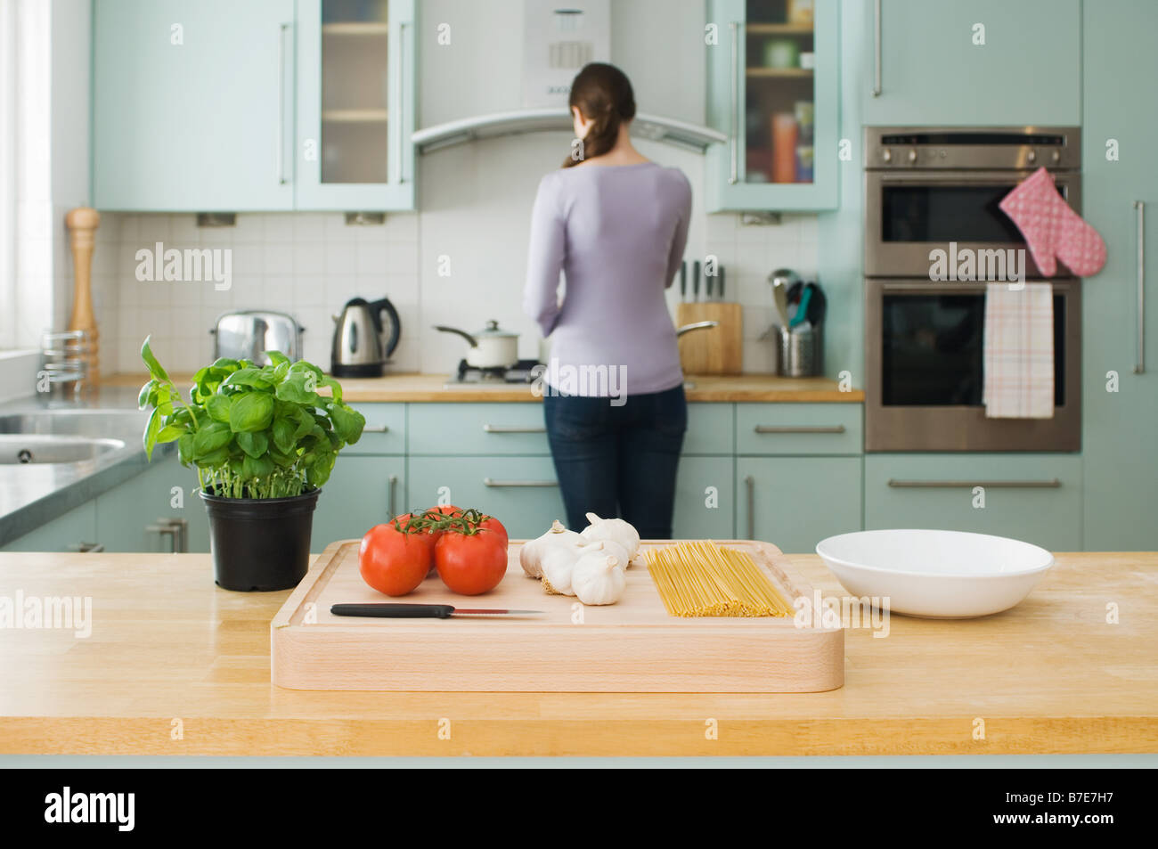 Woman in kitchen Stock Photo - Alamy