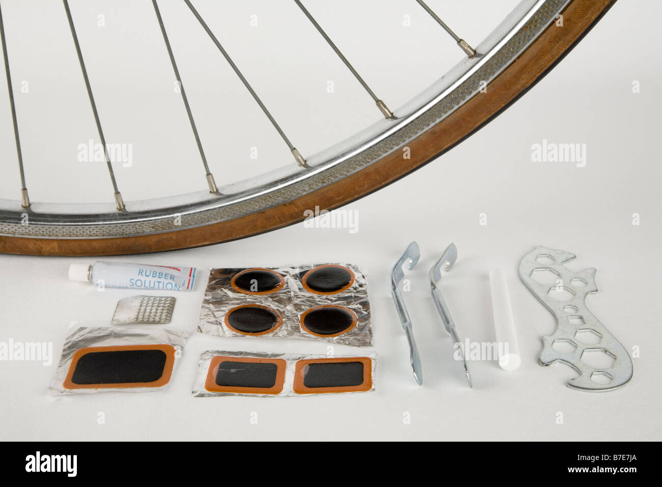 A bicycle repair kit next to a wheel Stock Photo - Alamy