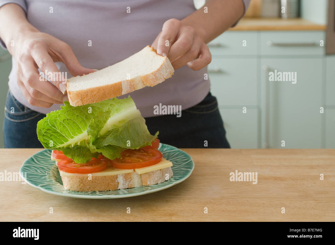 Woman making sandwich Stock Photo - Alamy